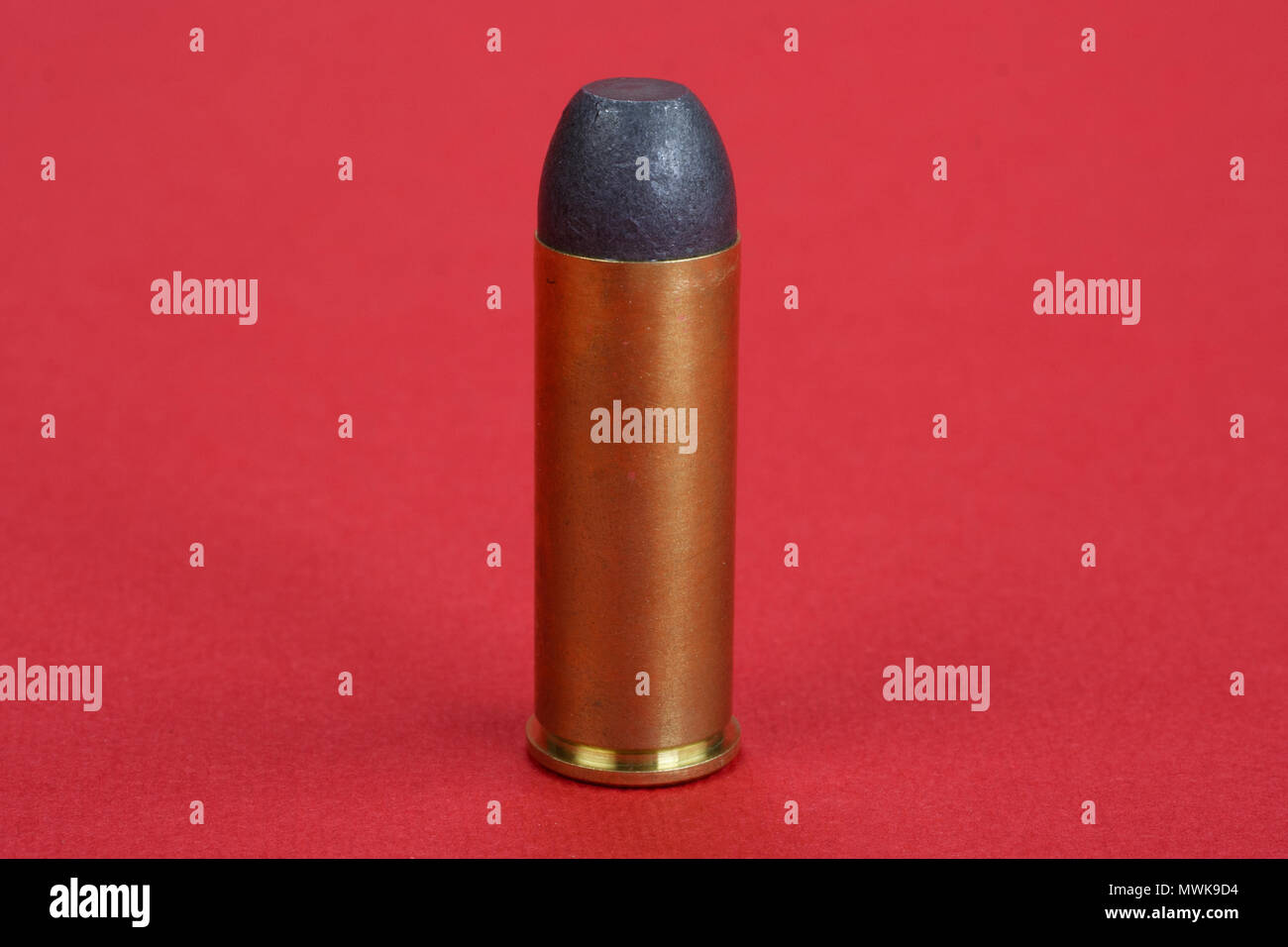 The .45 caliber revolver cartridges on red background Stock Photo - Alamy