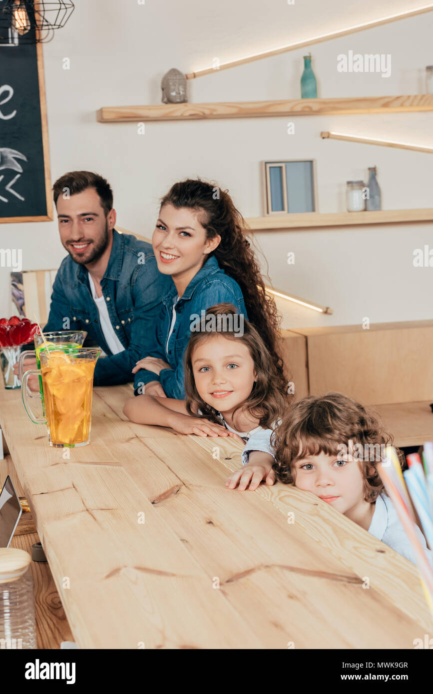 cheerful young family in cafe at bar counter Stock Photo - Alamy
