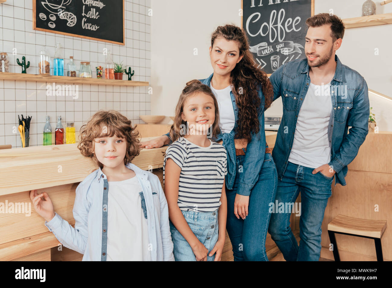beautiful happy young family in cafe at bar counter Stock Photo - Alamy