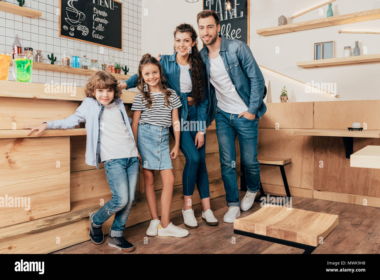 beautiful happy young family in cafe at bar counter Stock Photo - Alamy