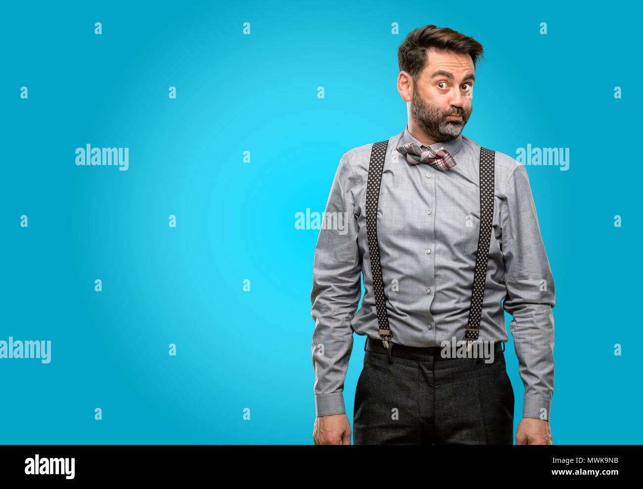 Middle age man, with beard and bow tie puffing out cheeks, having fun ...