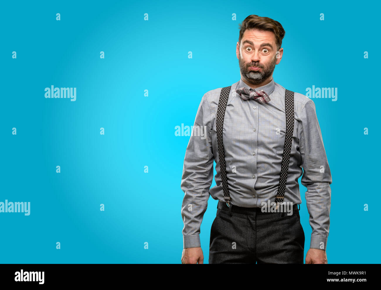 Middle age man, with beard and bow tie puffing out cheeks, having fun ...