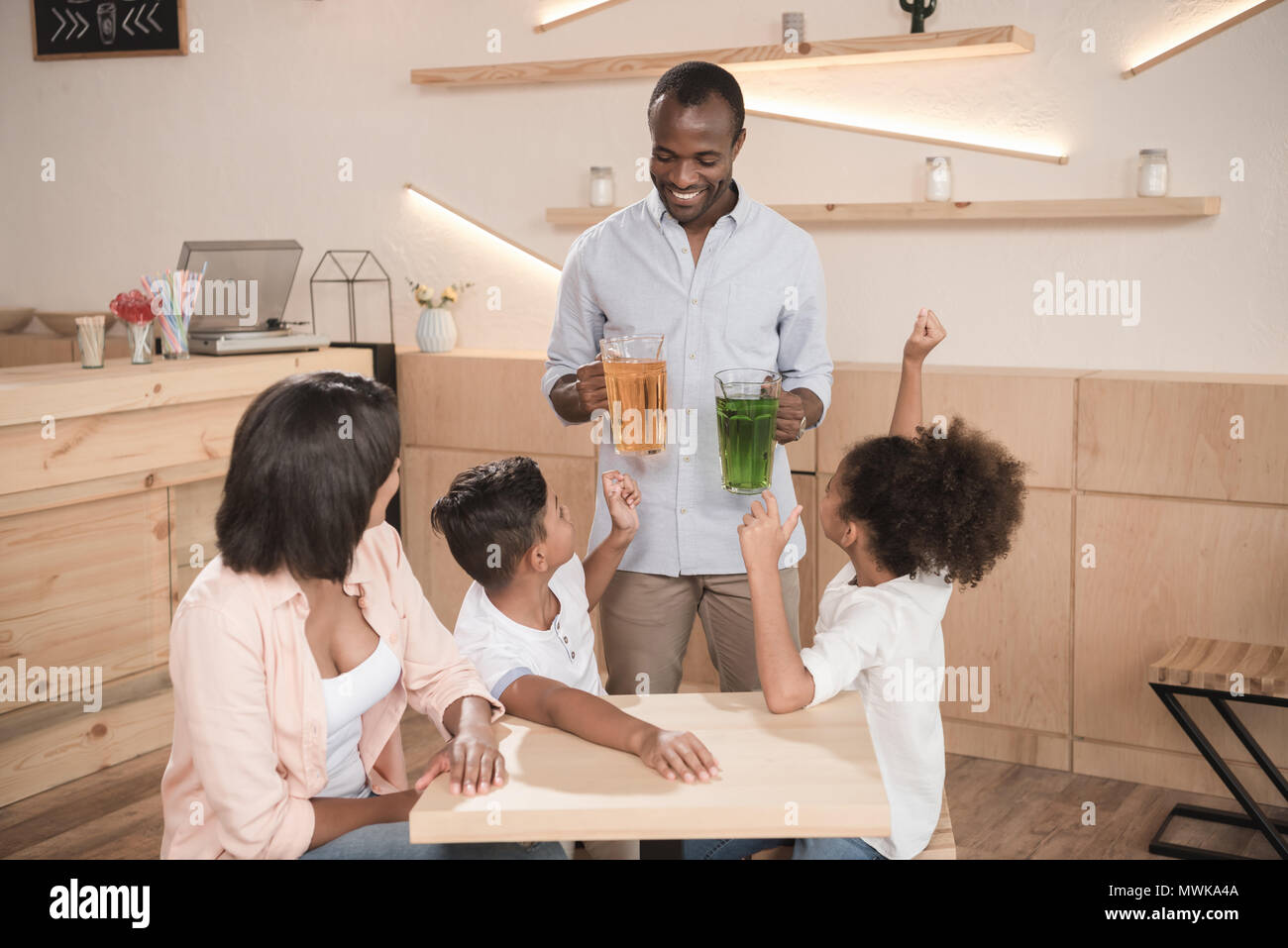 black man getting drinks for his family Stock Photo - Alamy