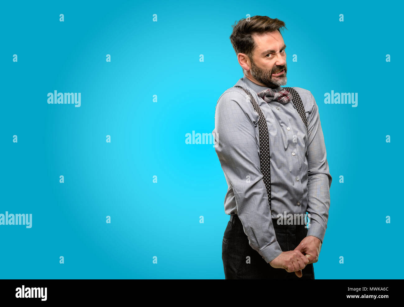 Middle age man, with beard and bow tie angry and stressful frowns face ...