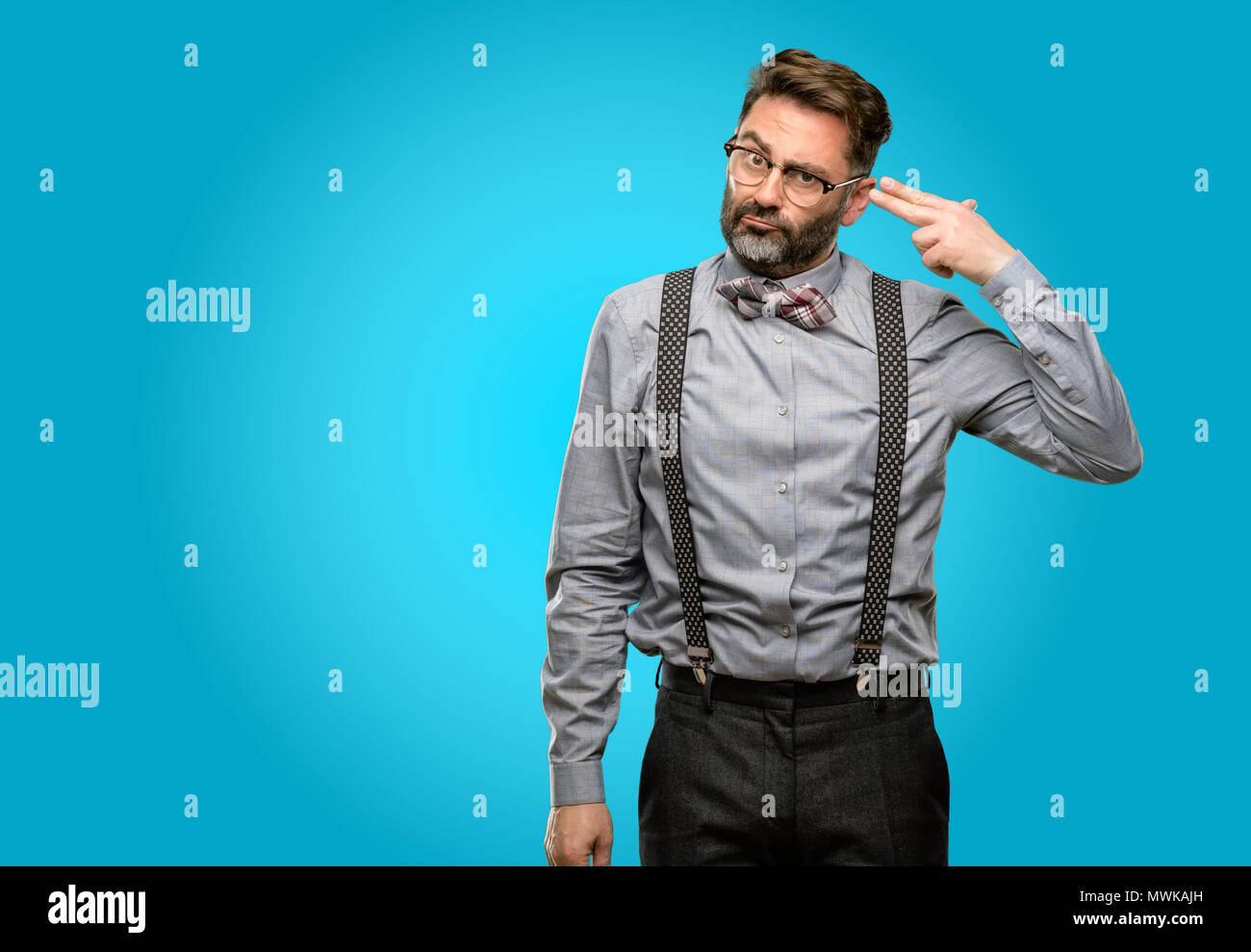 Middle age man, with beard and bow tie unhappy making suicide gesture ...