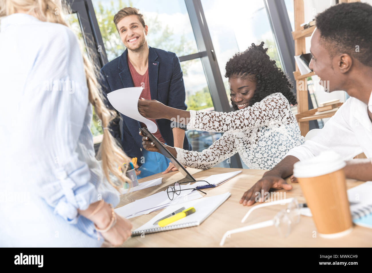 multicultural smiling business people discussing work at meeting in ...