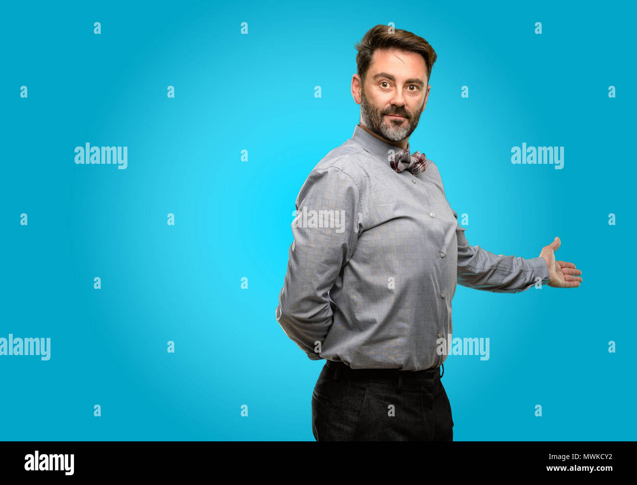 Middle age man, with beard and bow tie confident and happy with a big ...