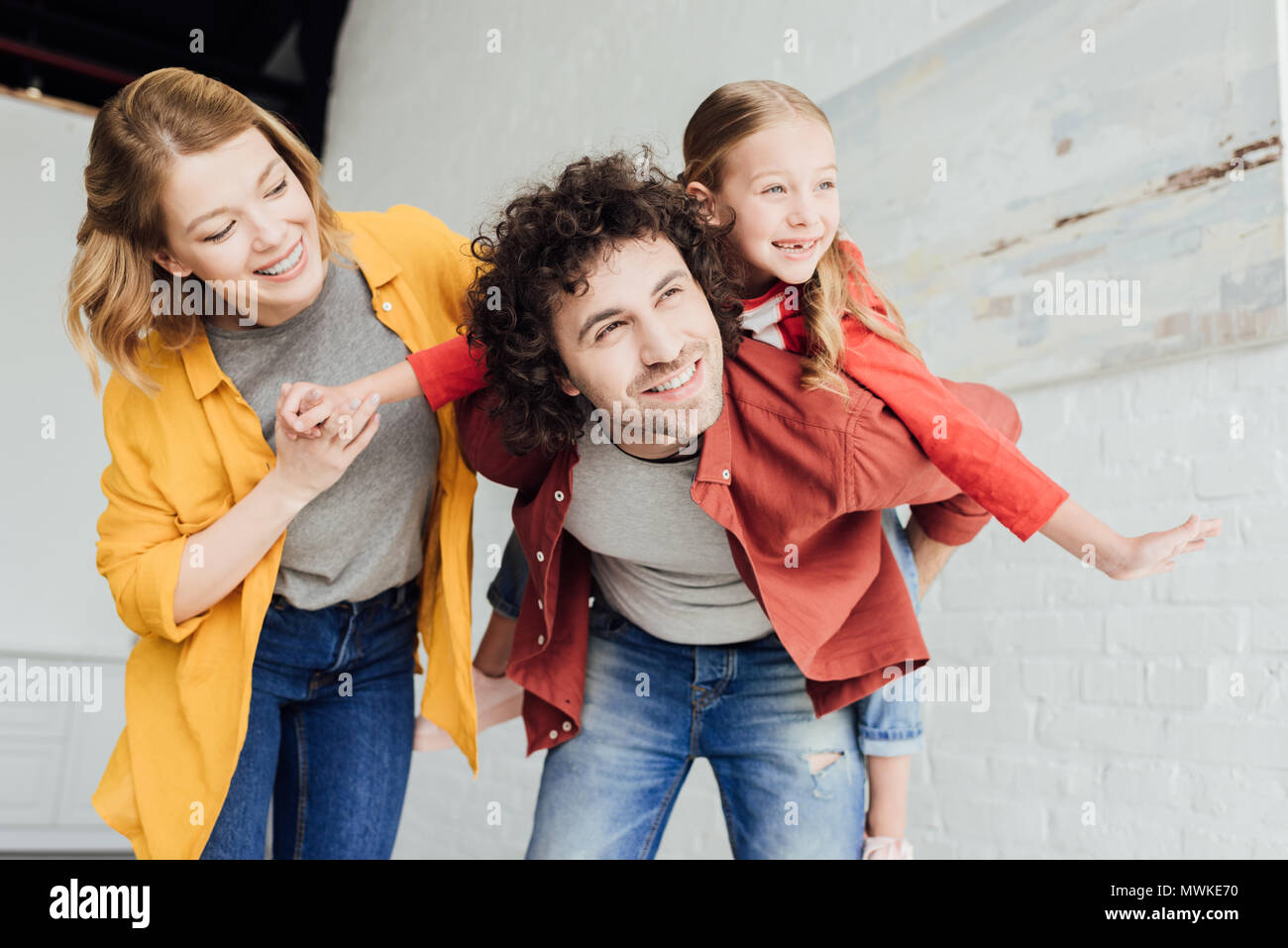 happy family with one child having fun together and looking away Stock ...