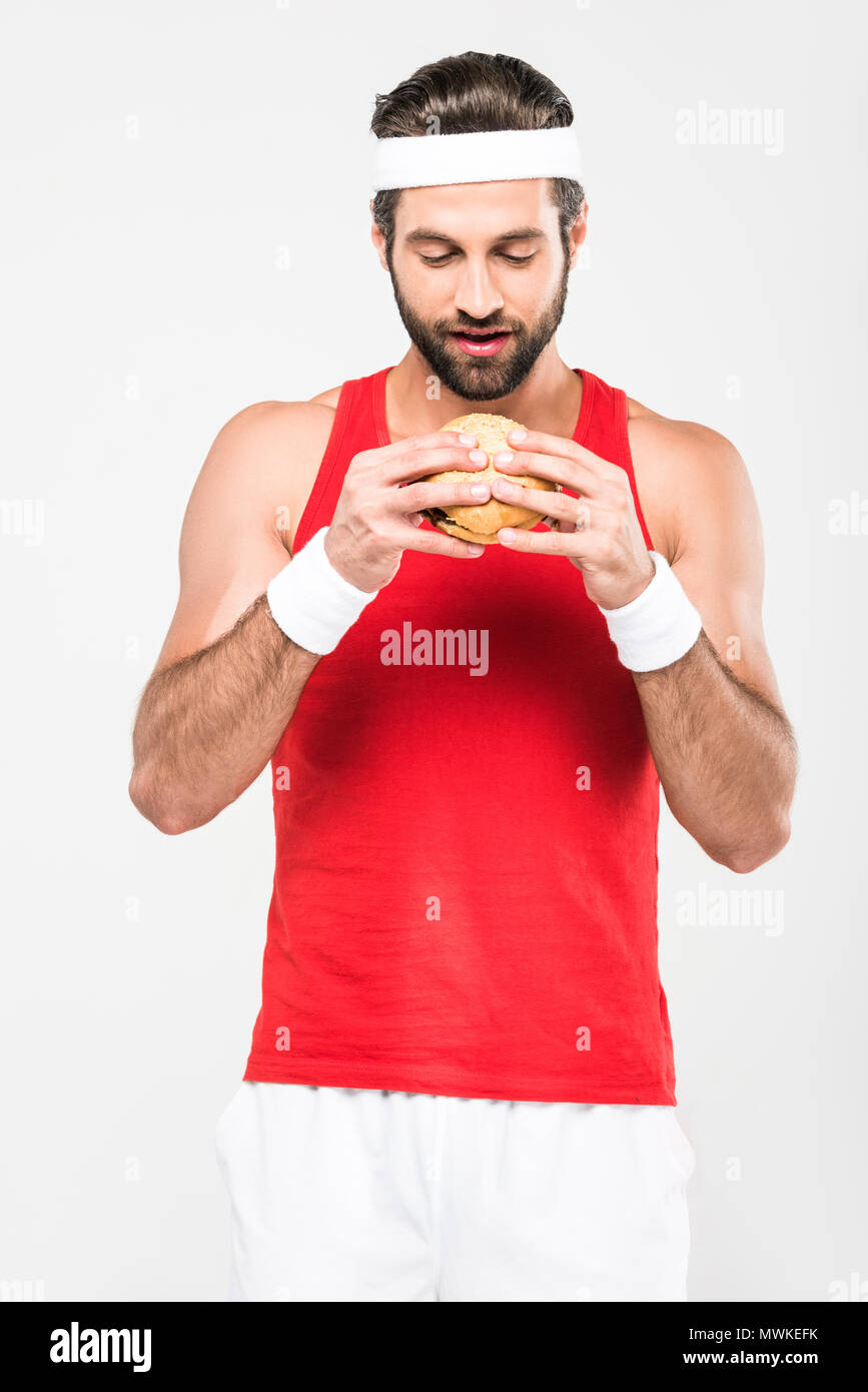 handsome sportsman eating fast food, isolated on white Stock Photo - Alamy