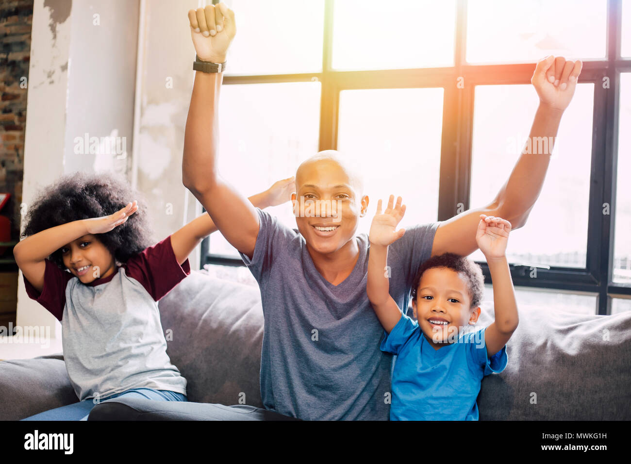 Happy kids arms raised together hi-res stock photography and images - Alamy