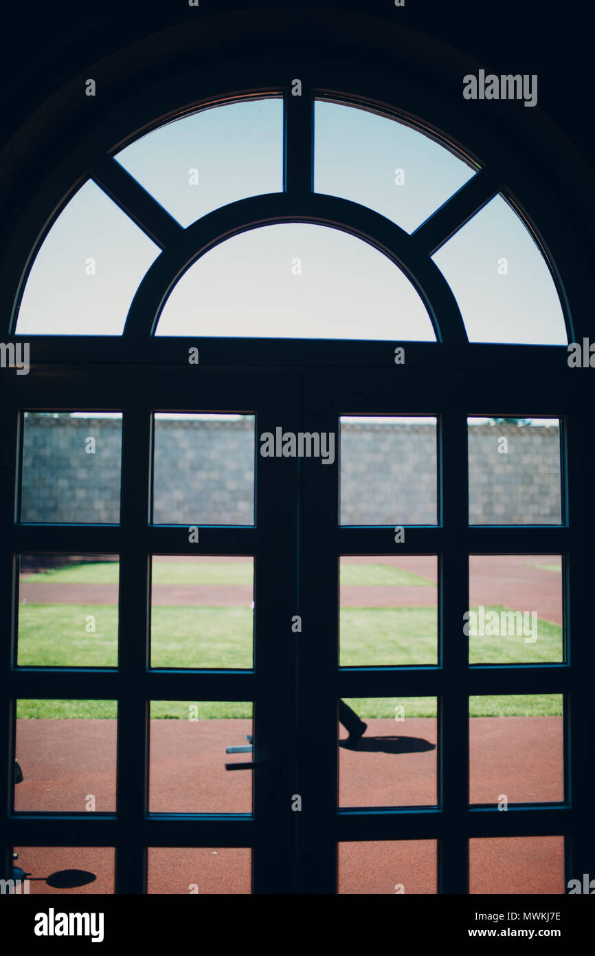 Vertical big window and man leg Stock Photo - Alamy