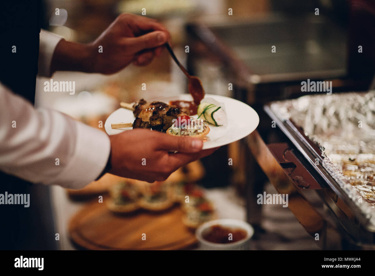 Hand and food. Catering concept Stock Photo - Alamy