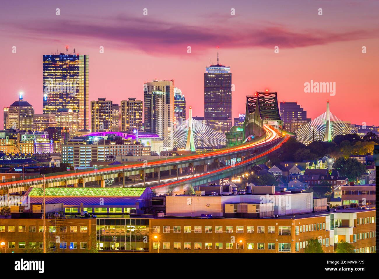 Boston, Massachusetts, USA skyline with bridges and highways at dusk ...