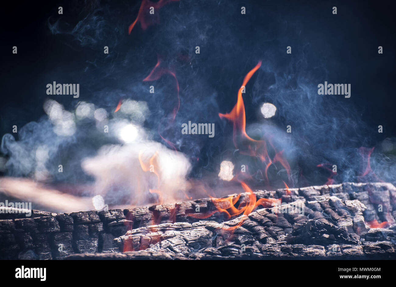 Firewood is burning in the grill Stock Photo - Alamy