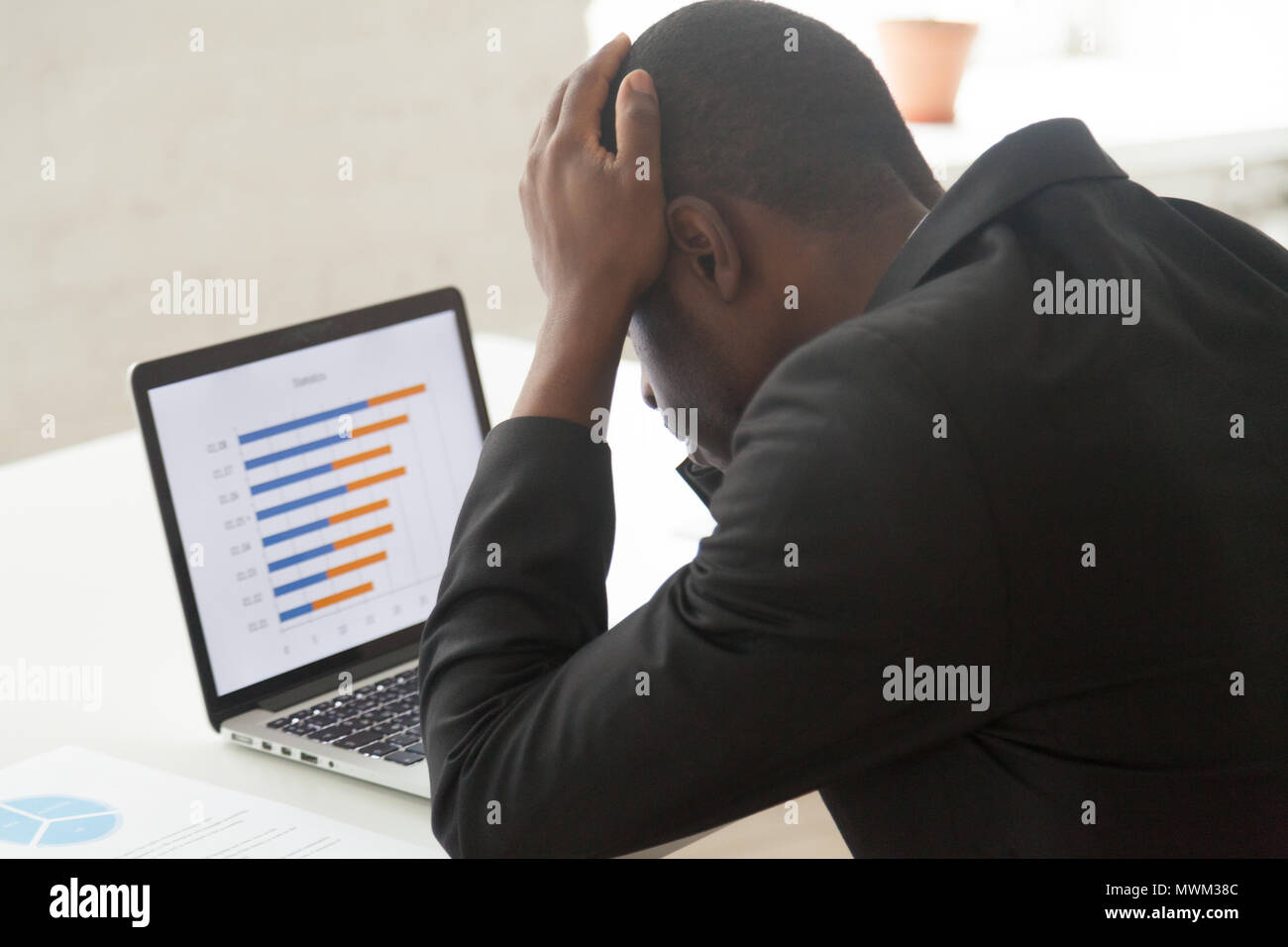 Stressed African American worker observing company business coll Stock ...