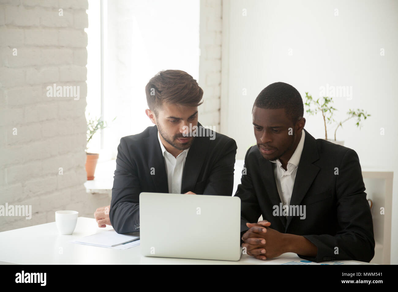 Successful diverse business partners review hi-res stock photography ...