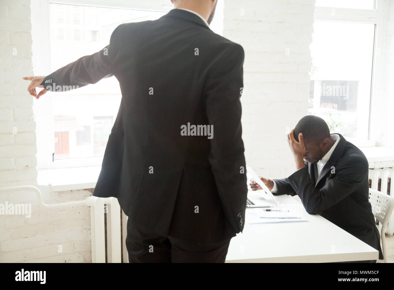 Angry employer asking fired African American worker to leave Stock ...