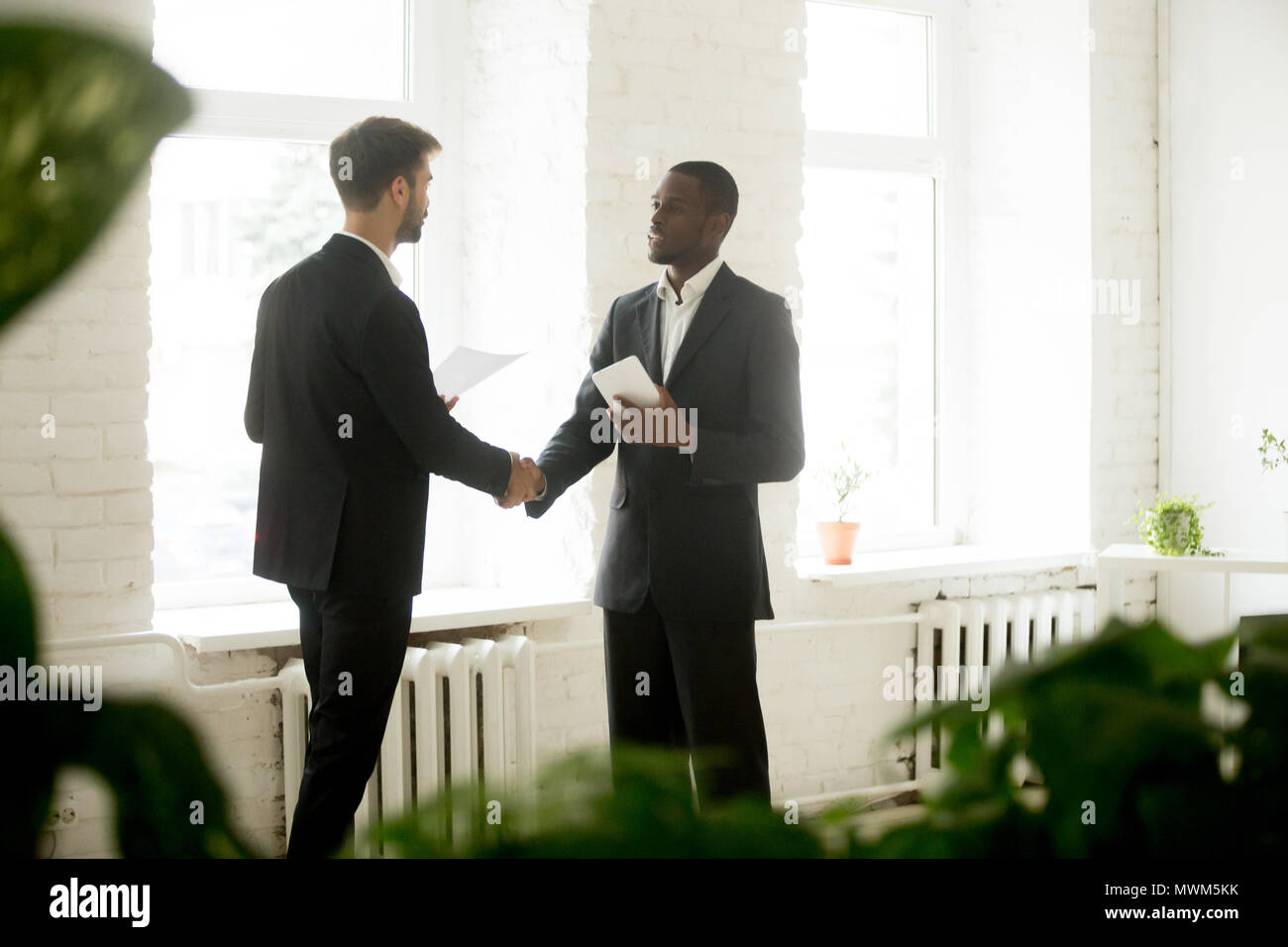 African American businessman congratulating partner with handsha Stock ...