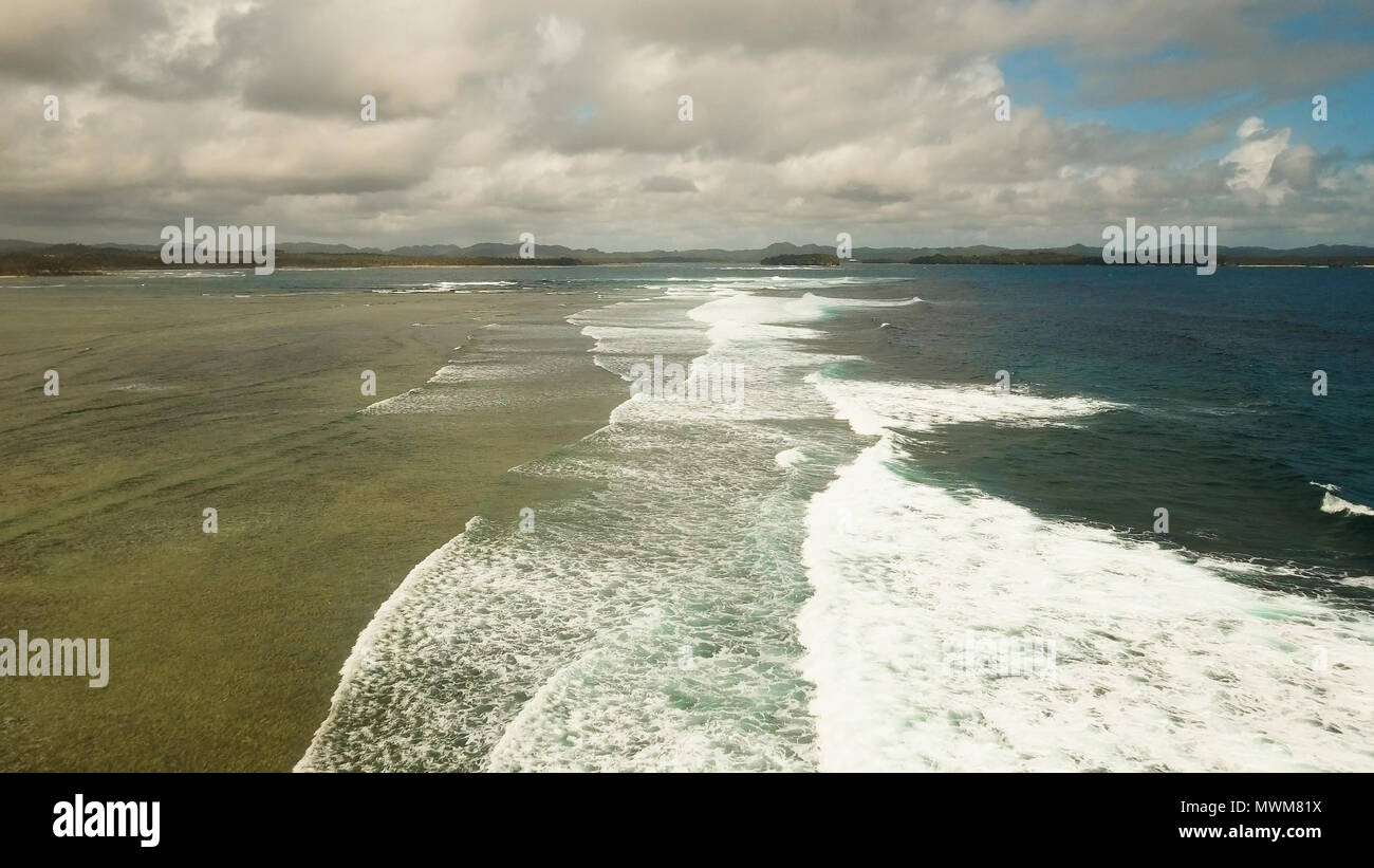 Flying over the blue sea in the azure lagoon. Aerial view: water ...