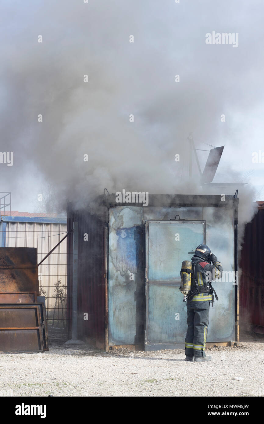 Firefighter putting out fire training station extinguisher backdraft ...