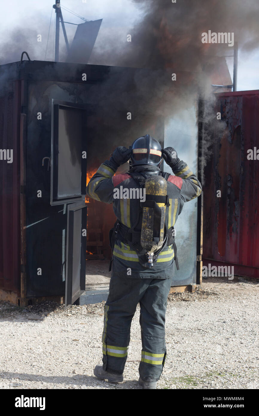 Firefighter putting out fire training station extinguisher backdraft ...
