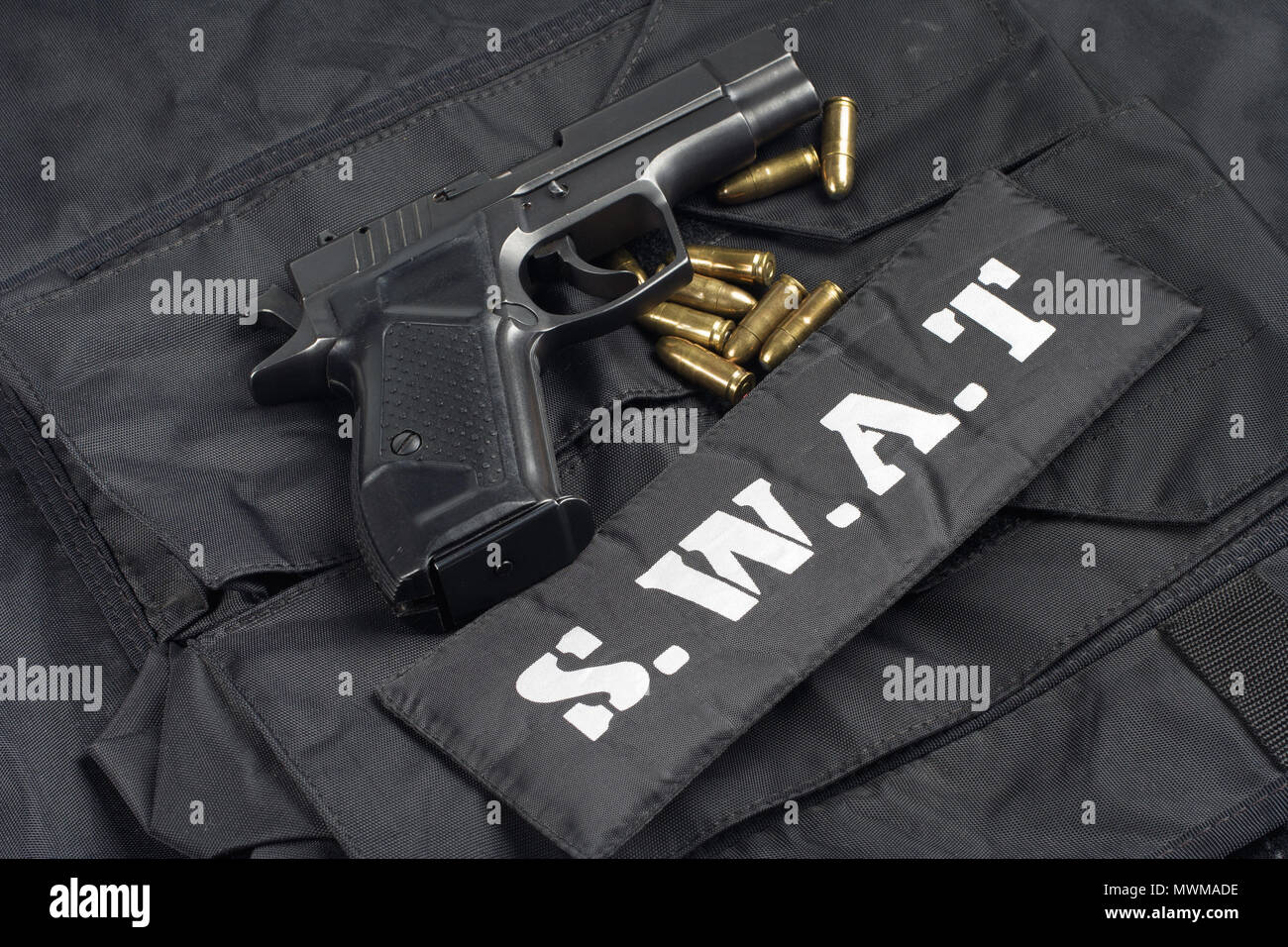 handgun on SWAT black uniform background Stock Photo - Alamy