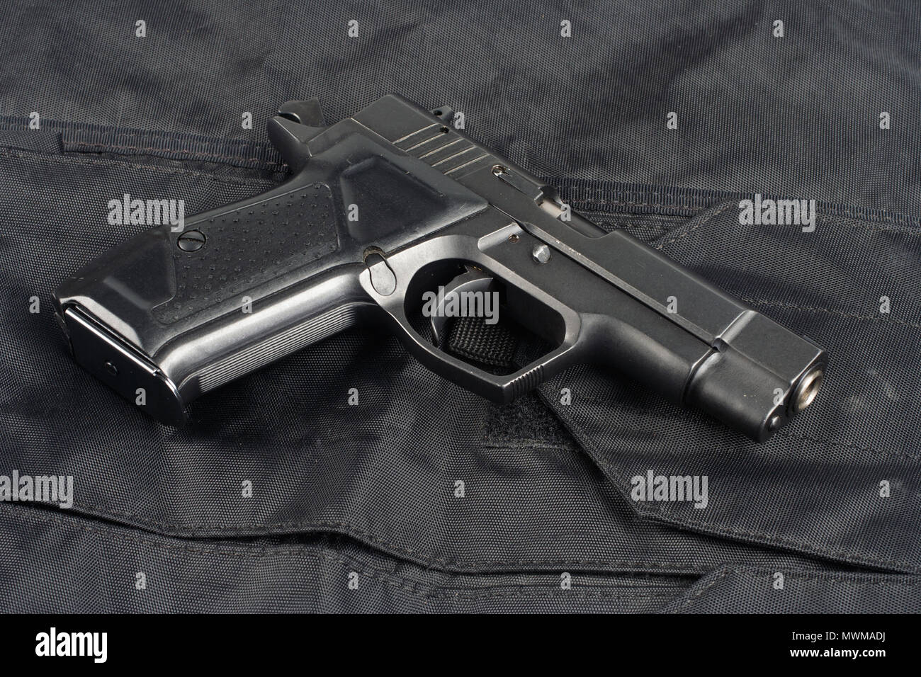 handgun on SWAT black uniform background Stock Photo - Alamy