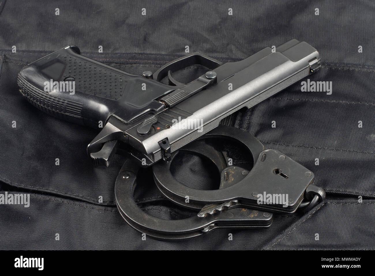 handgun on SWAT black uniform background Stock Photo - Alamy