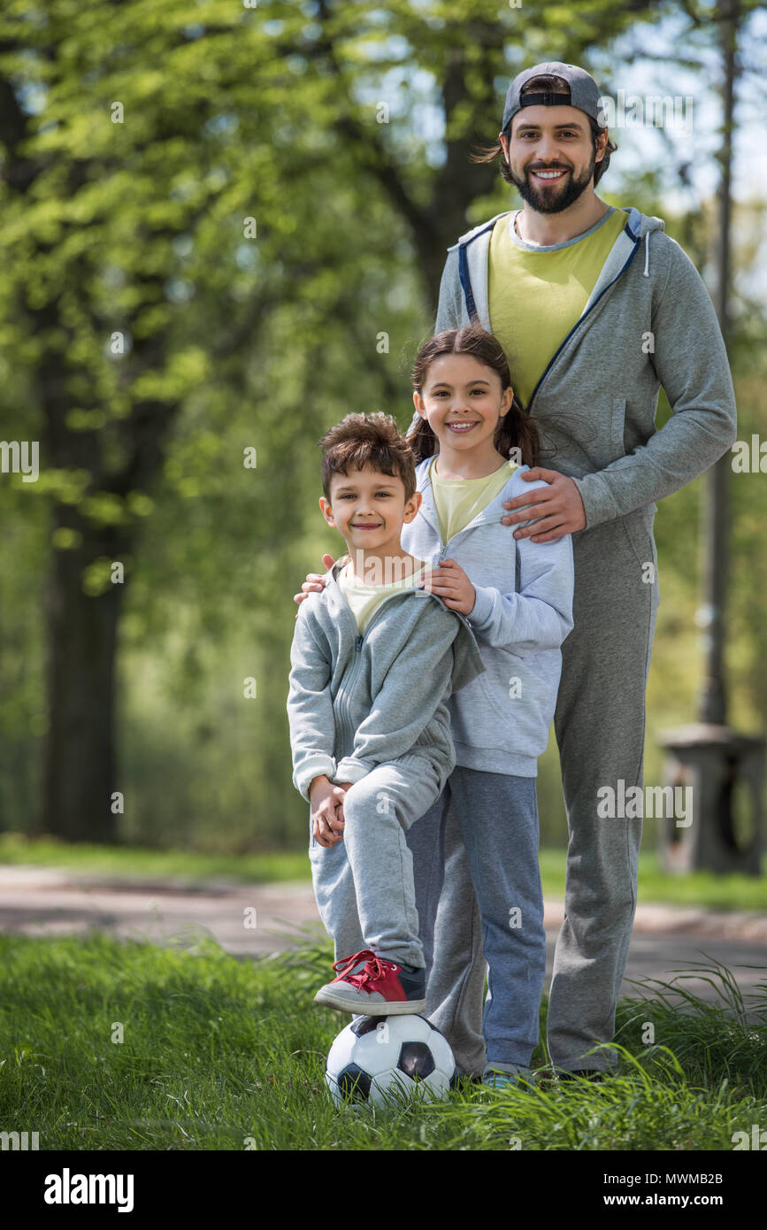 sportive family with soccer ball in park Stock Photo - Alamy