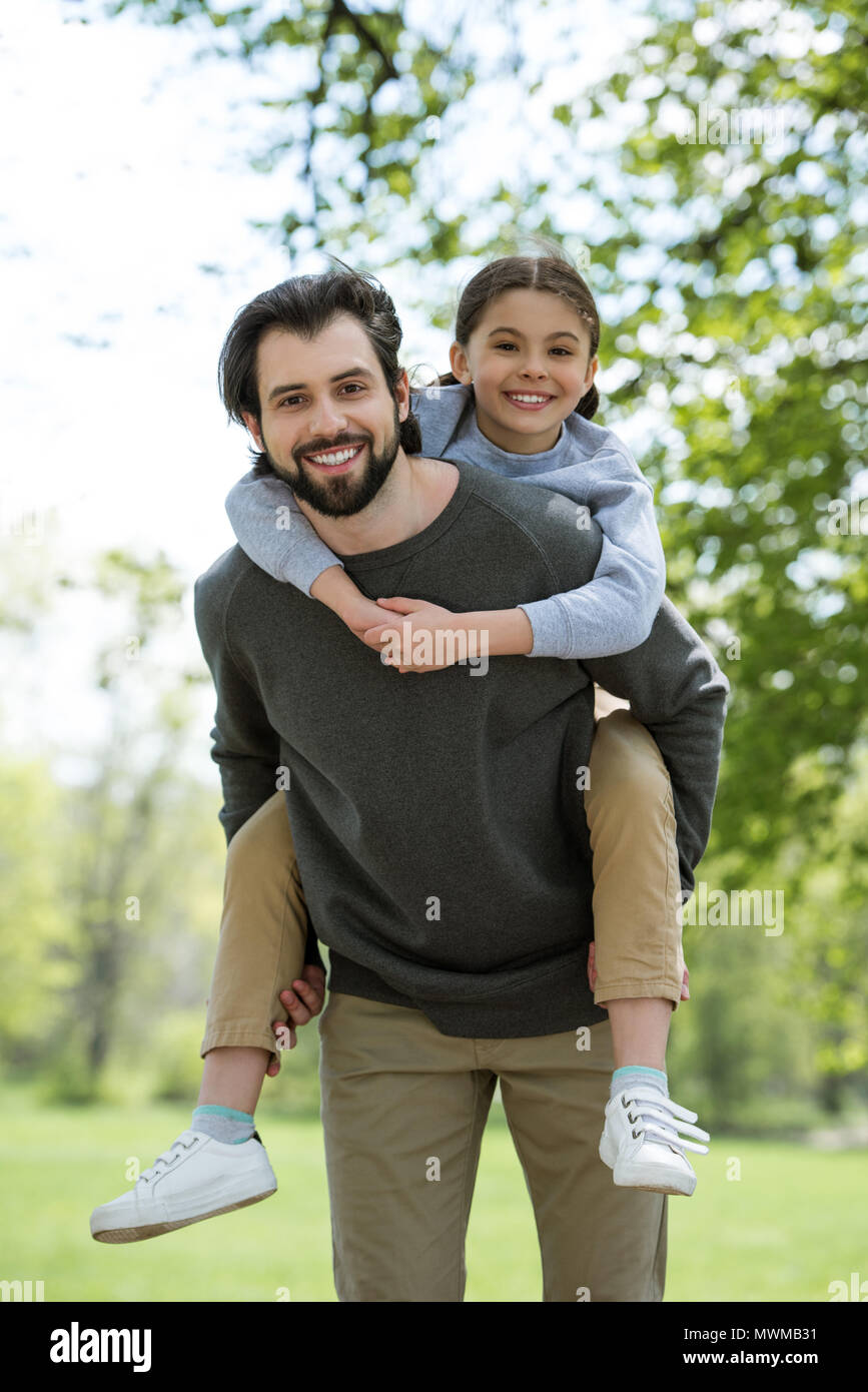 Daughter sitting on father hi-res stock photography and images - Alamy