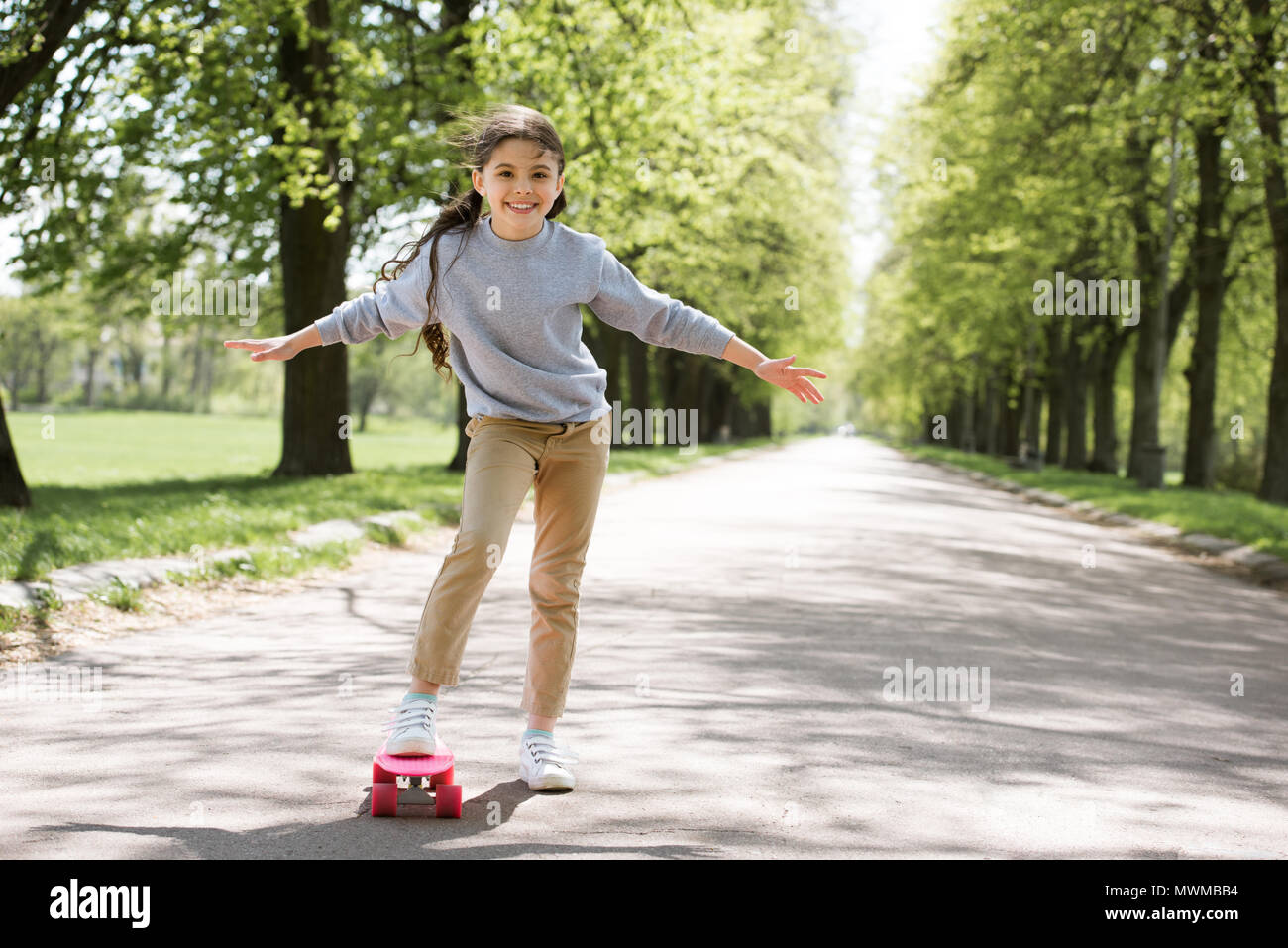 little child with skateboard on path in park Stock Photo - Alamy
