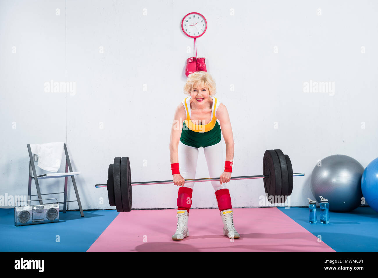 Elderly lady lifting barbell hi-res stock photography and images - Alamy