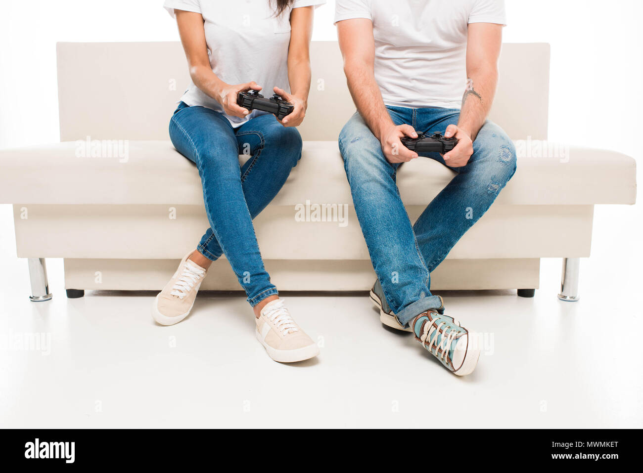 'Cropped view of young couple playing video game using joysticks ...