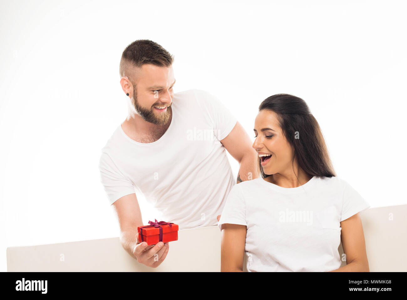 Portrait Of Young Attractive Man Surprising His Girlfriend By T