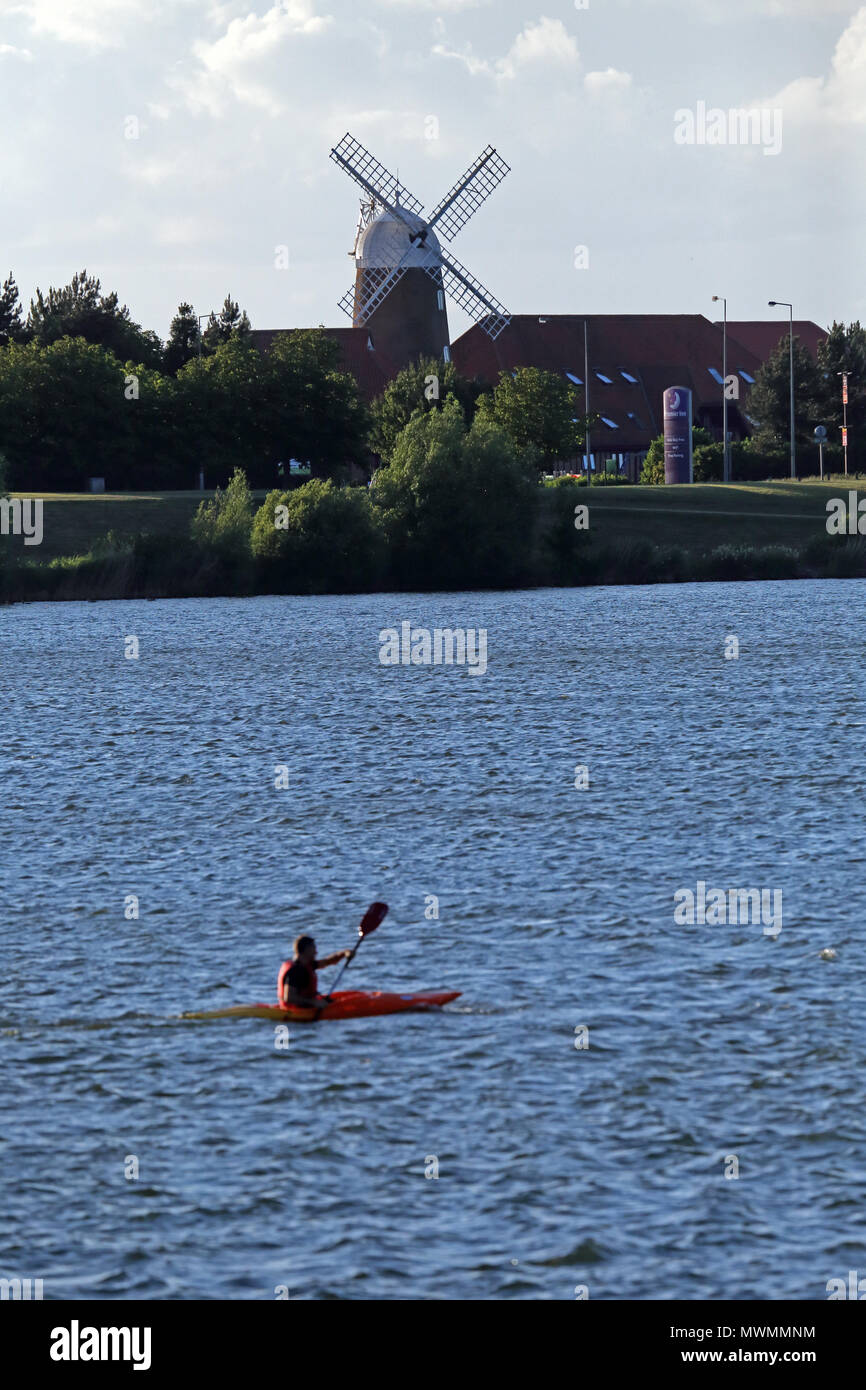 Kayaker on Caldecotte Lake, Milton Keynes, UK, with the Caldecotte Arms ...