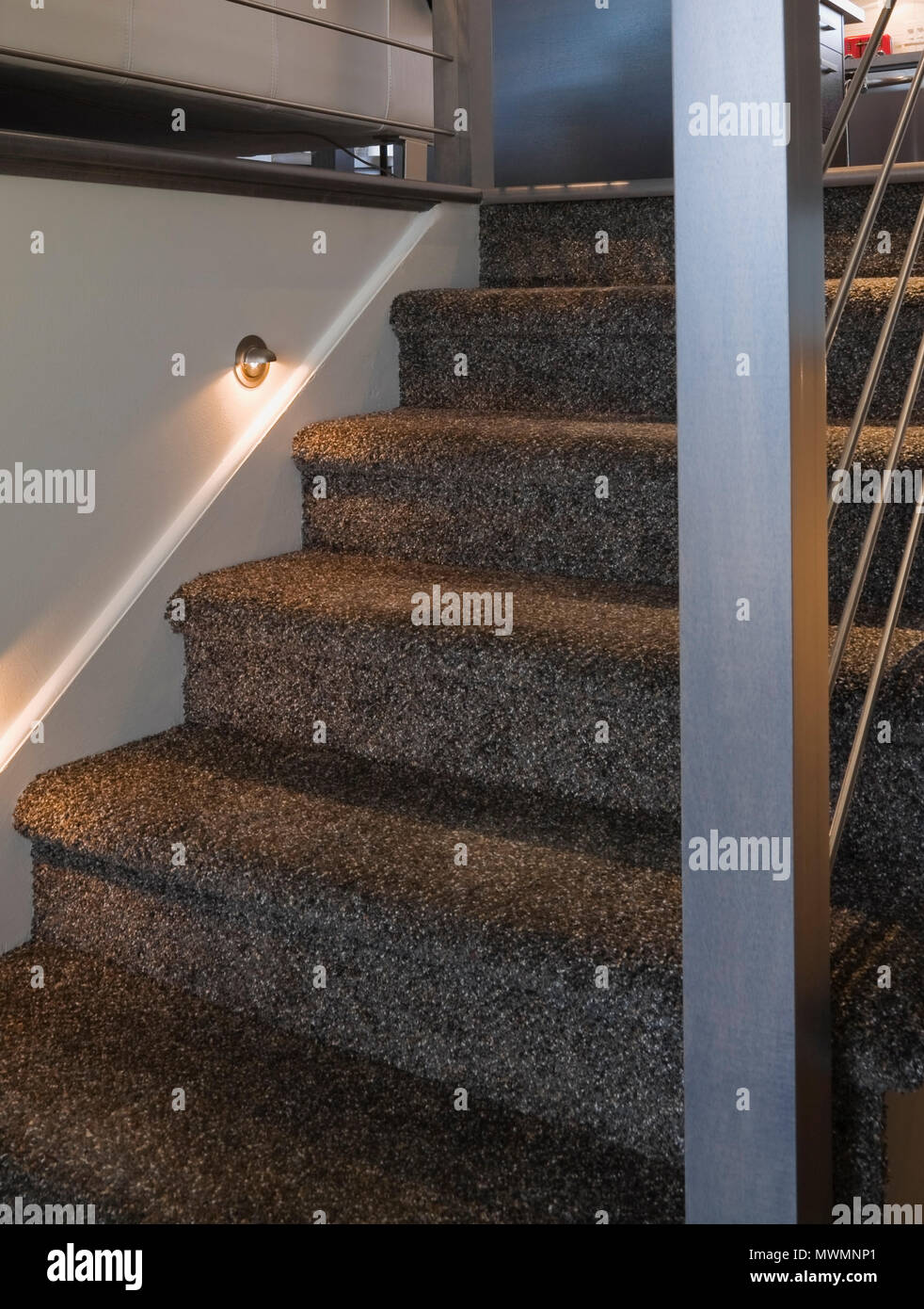 Carpeted staircase inside a modern split-level style residential home ...