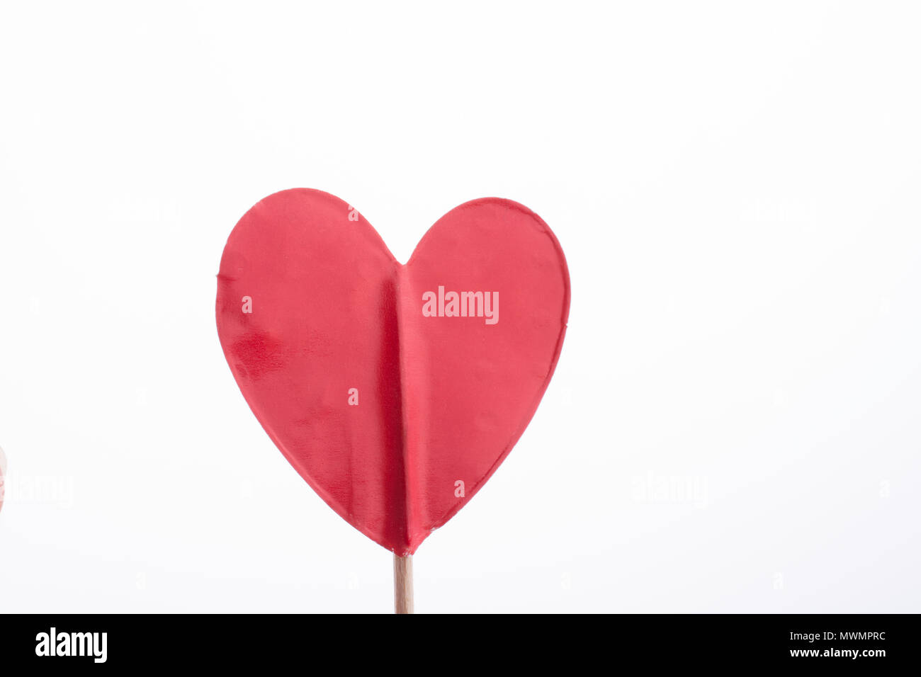 Little red color heart shape at the top of a stick Stock Photo - Alamy