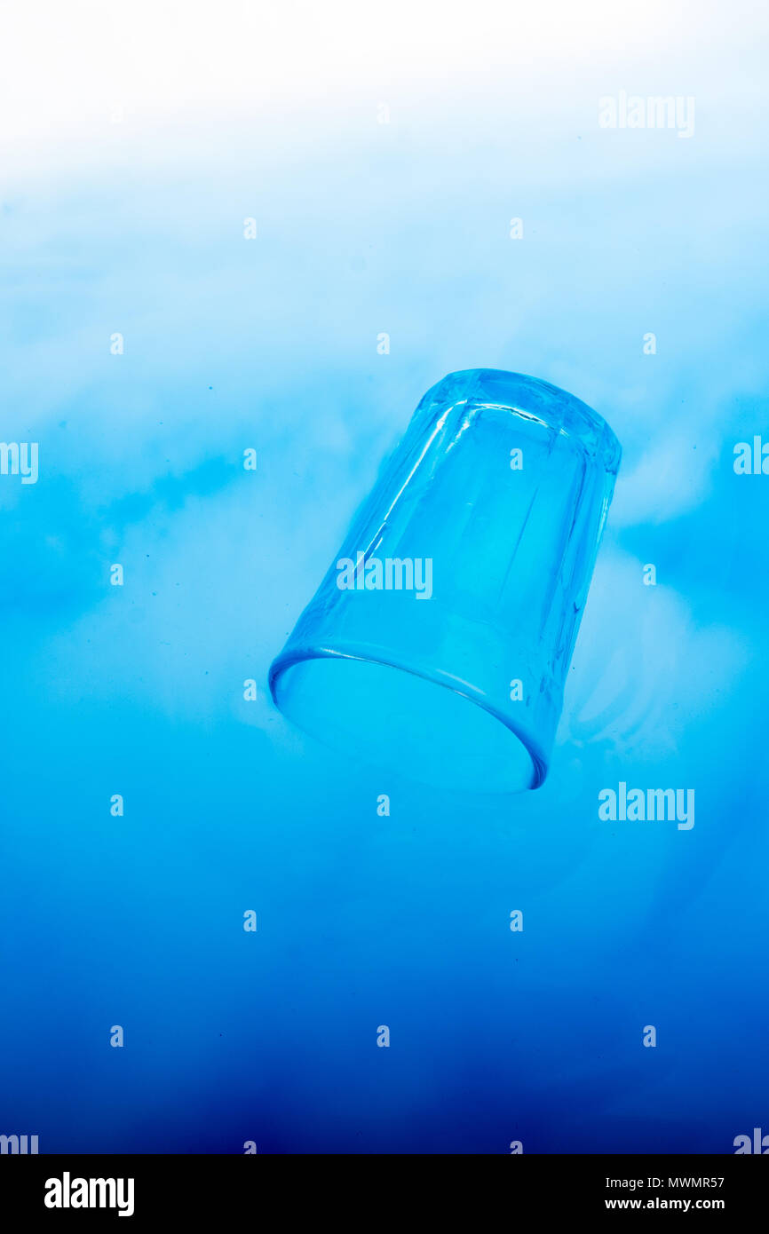 Blue color glass is placed in blue color water Stock Photo - Alamy