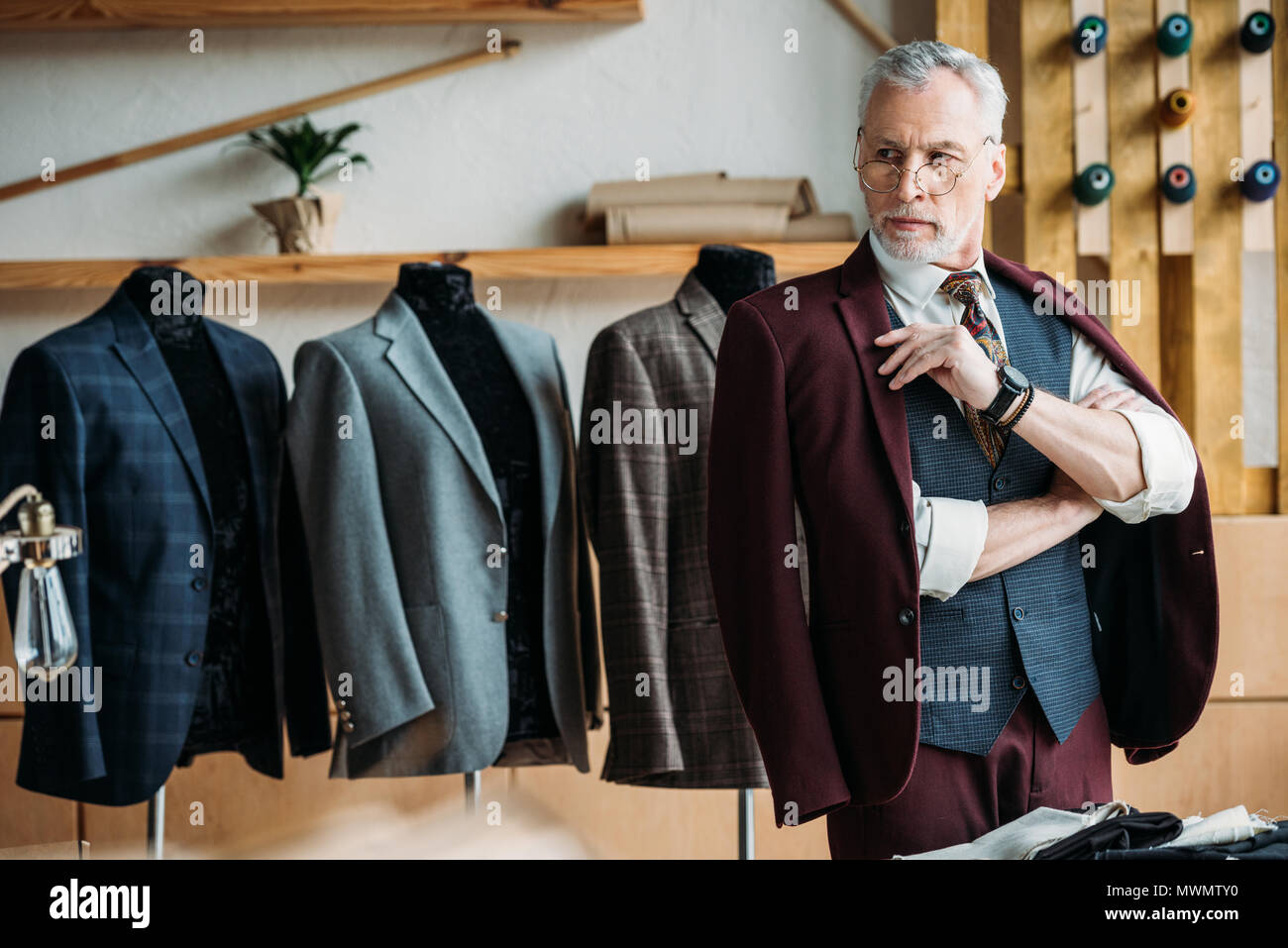 Serious handsome tailor sewing hi-res stock photography and images - Alamy