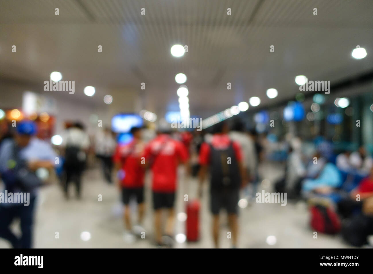 Blurred defocused image of passengers check in at the check-in counter ...