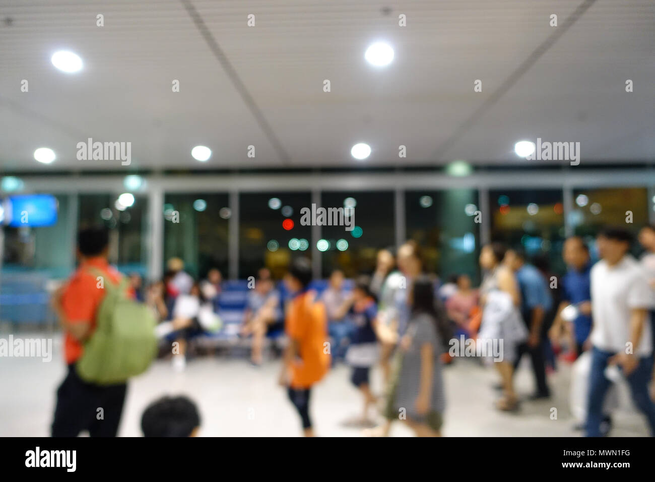 Blurred defocused image of passengers check in at the check-in counter ...