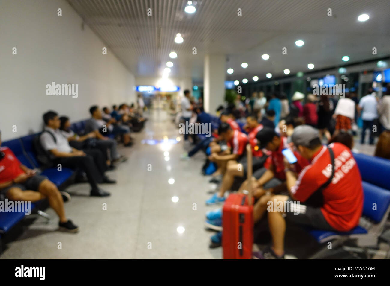 Blurred defocused image of passengers check in at the check-in counter ...