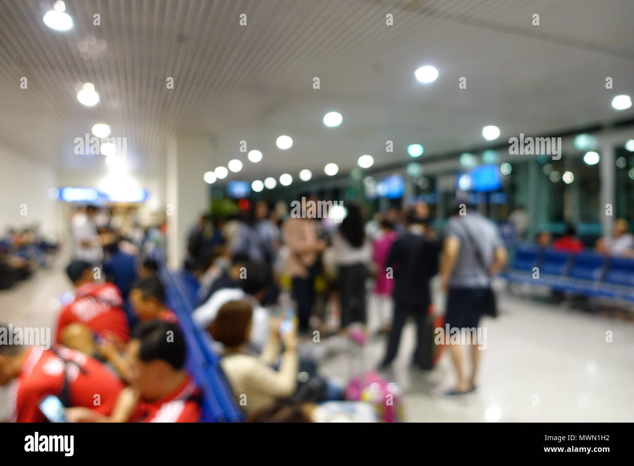 Blurred defocused image of passengers check in at the check-in counter ...