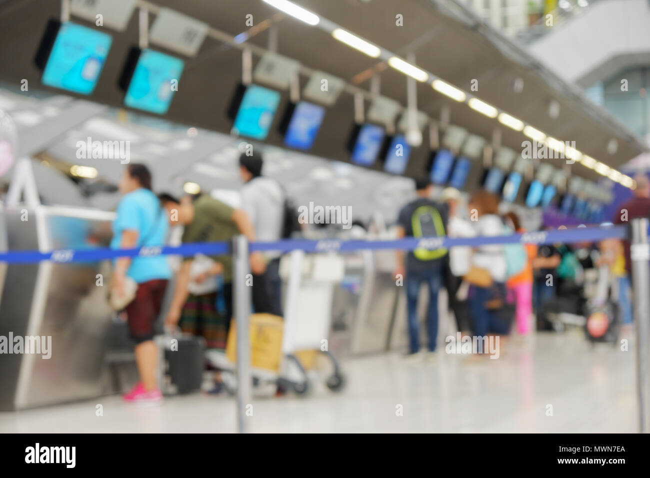 Blurred defocused image of passengers check in at the check-in counter ...