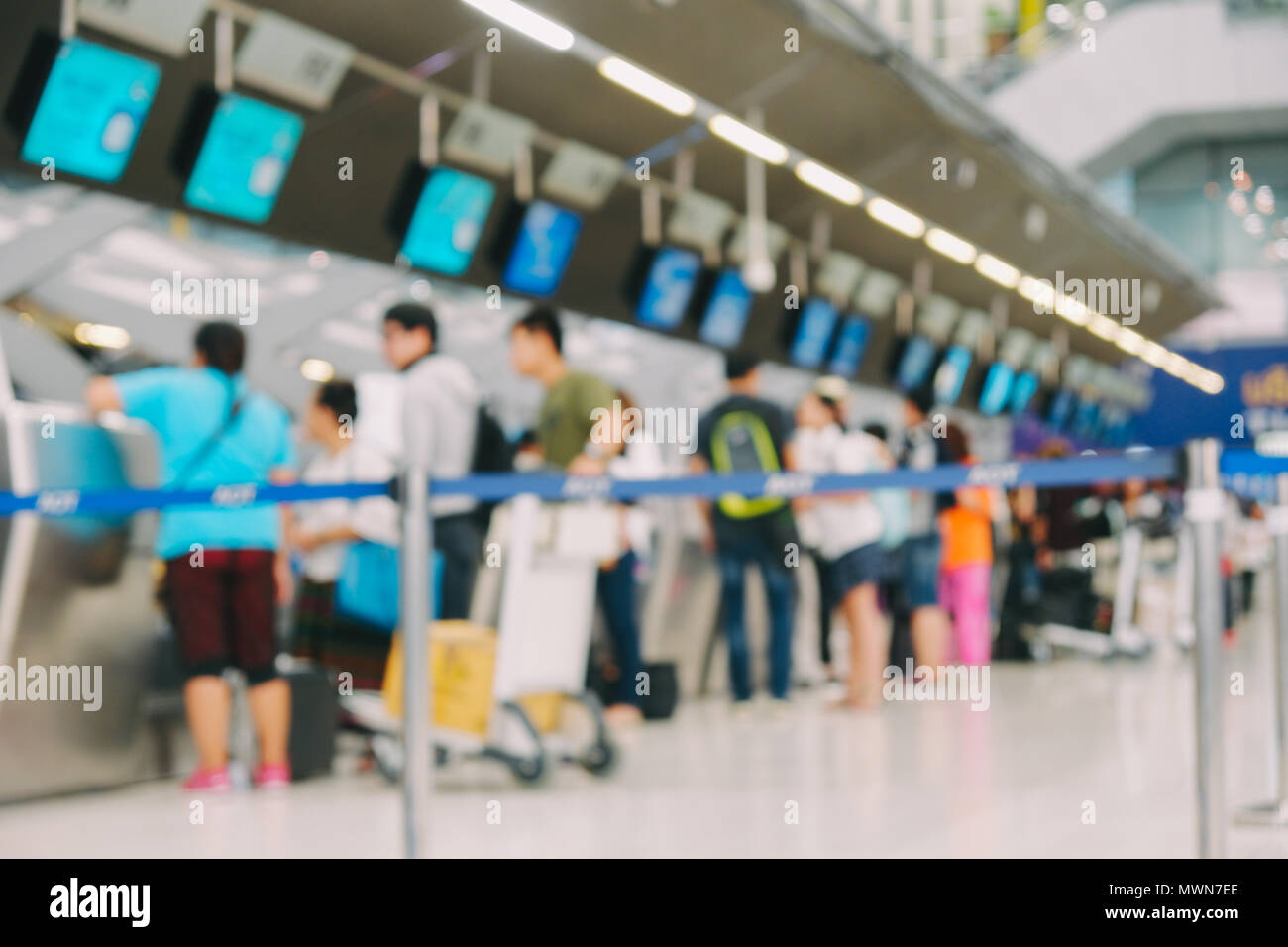 Blurred defocused image of passengers check in at the check-in counter ...