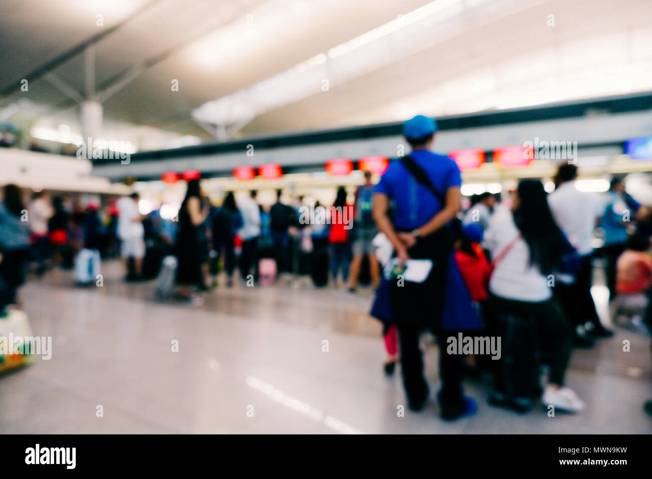 Blurred defocused image of passengers check in at the check-in counter ...