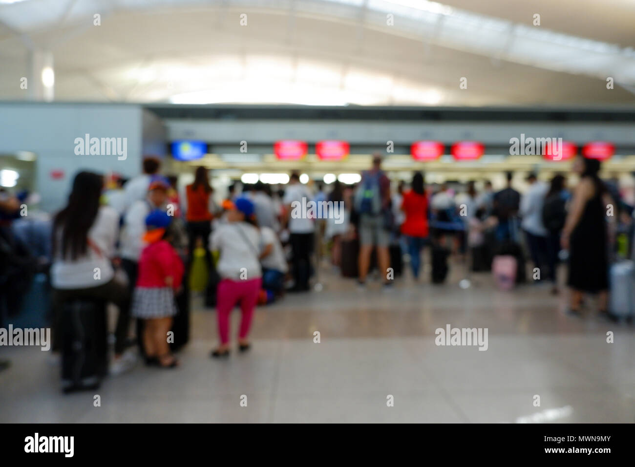 Blurred defocused image of passengers check in at the check-in counter ...