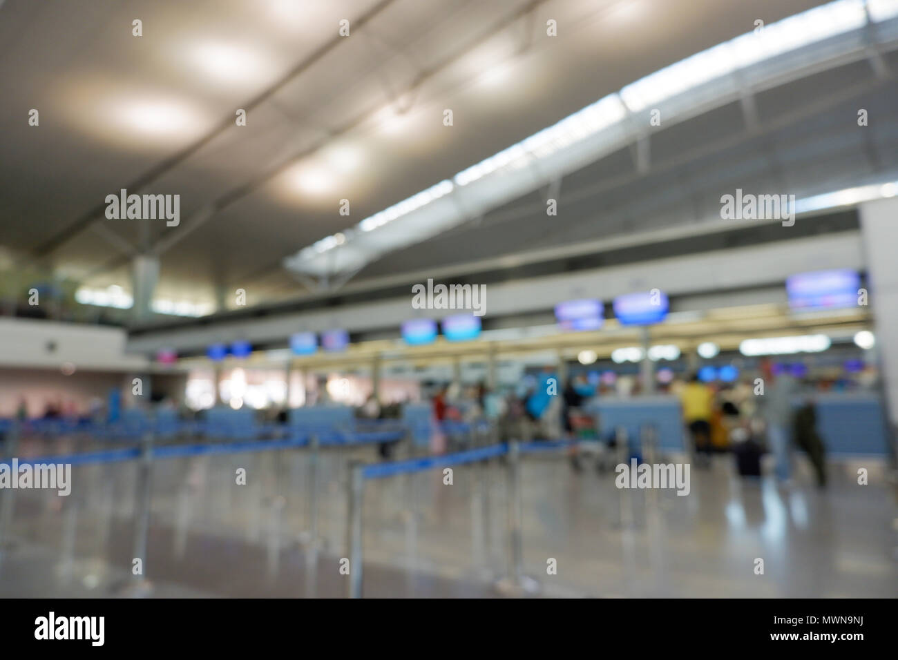 Blurred defocused image of passengers check in at the check-in counter ...