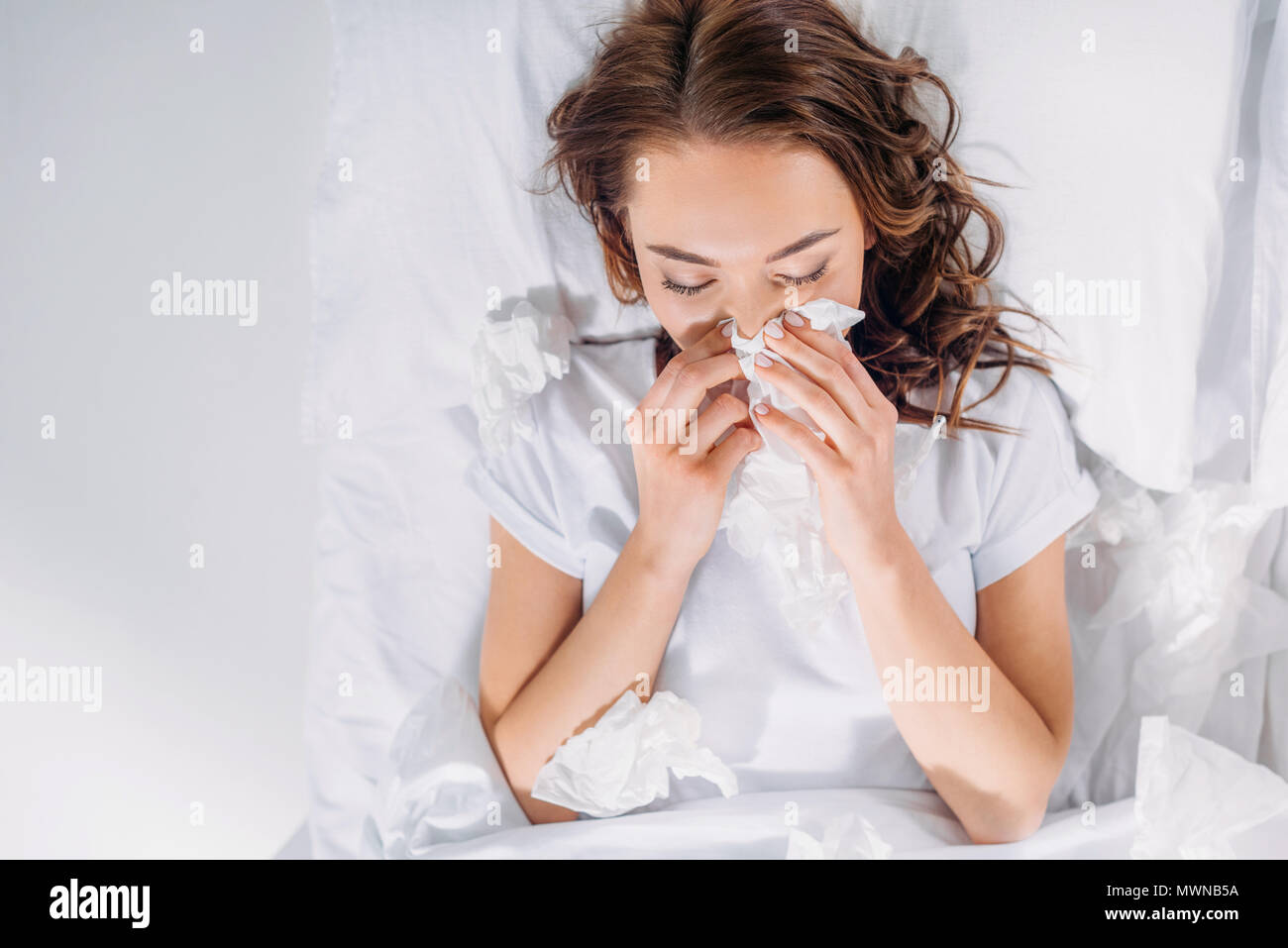 overhead view of woman having running nose and resting in bed Stock ...