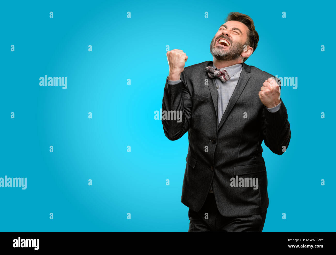 Middle age man, with beard and bow tie happy and excited celebrating ...